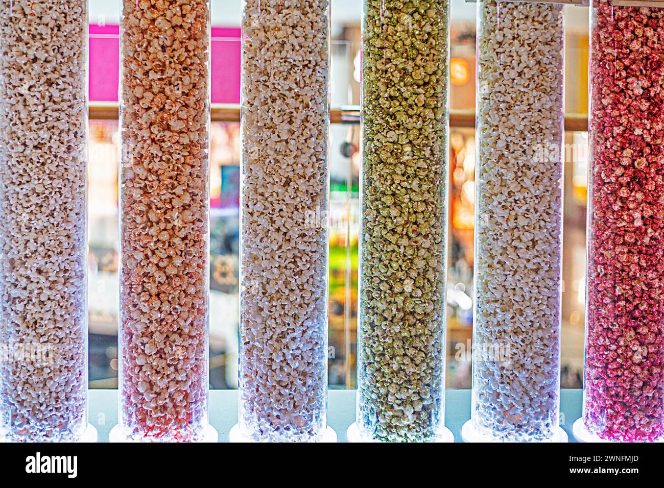 different flavors of popcorn in glass containers in a movie theater ...