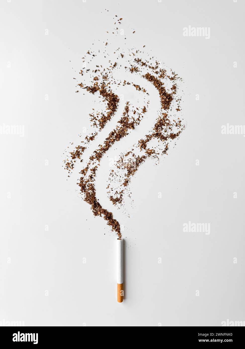 Cigarette with tobacco spilling out in smoke trail shape on white ...
