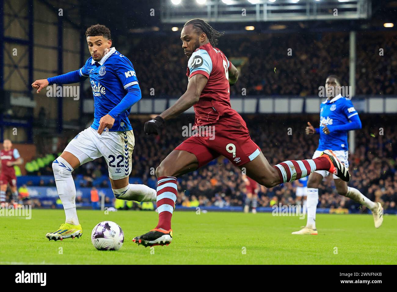 Michail Antonio of West Ham United runs past Ben Godfrey of Everton ...