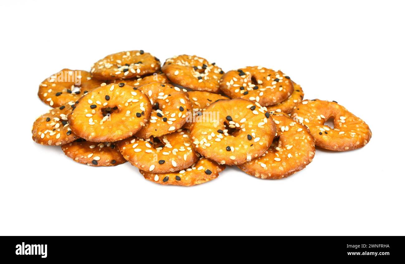 Salted round pretzels with black and white sesame isolated on white ...