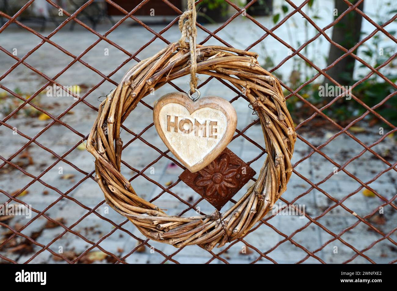 a heart decoration on a on the metal gate with the lettering home Stock ...