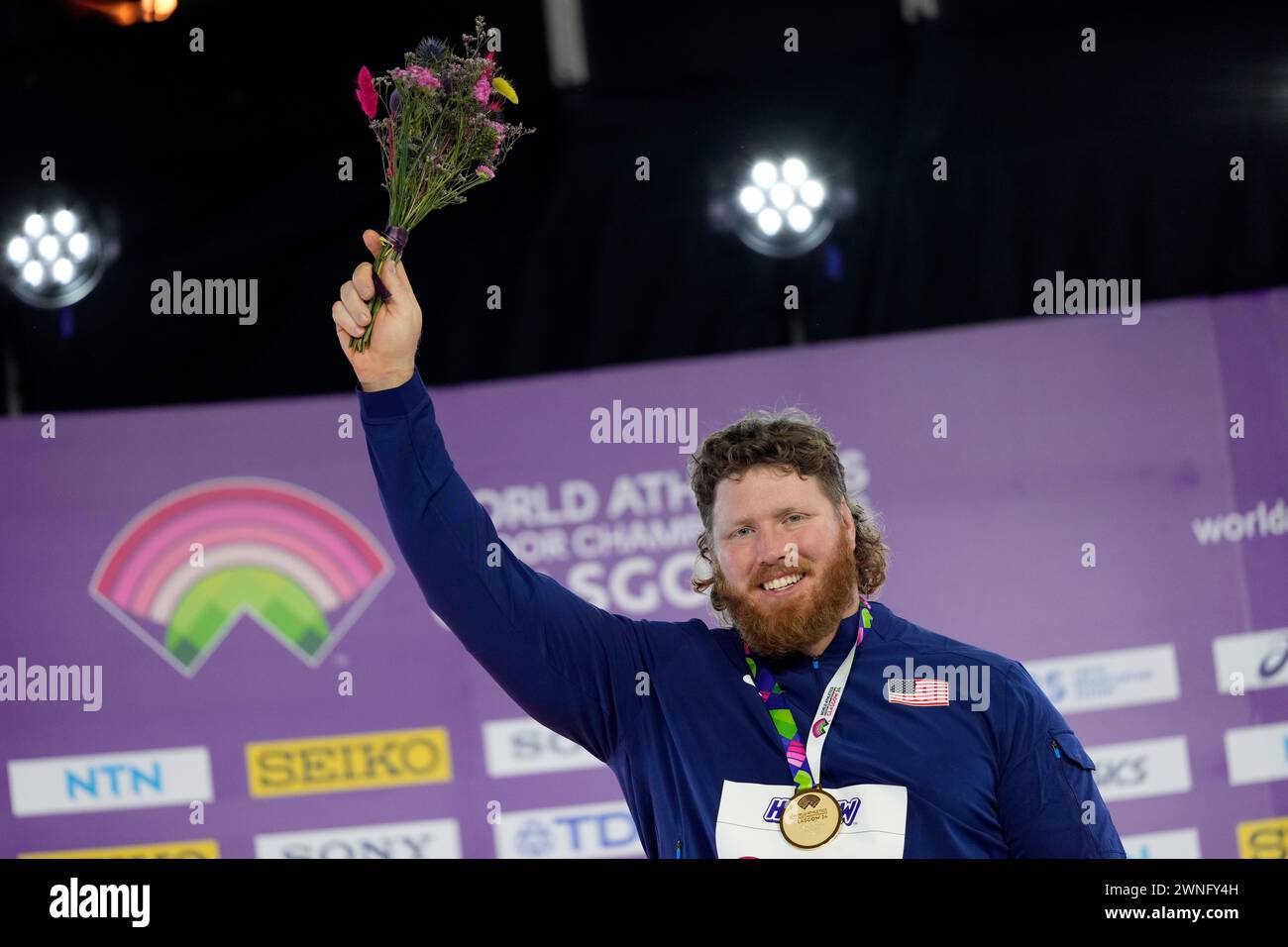 Ryan Crouser, of the United States, stands with his gold medal on the ...
