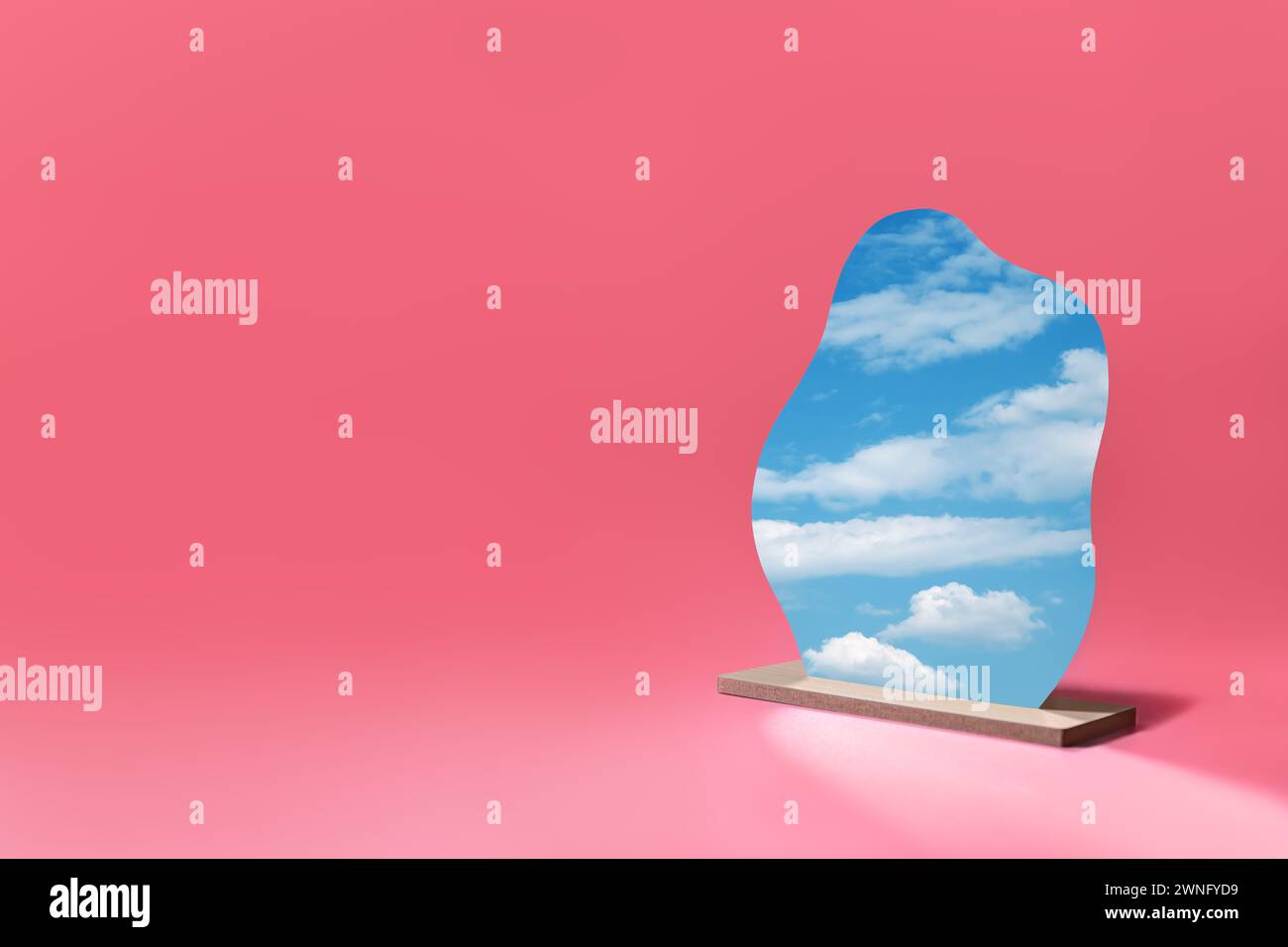 creative composition. wavy mirror on a pink background, white clouds in ...