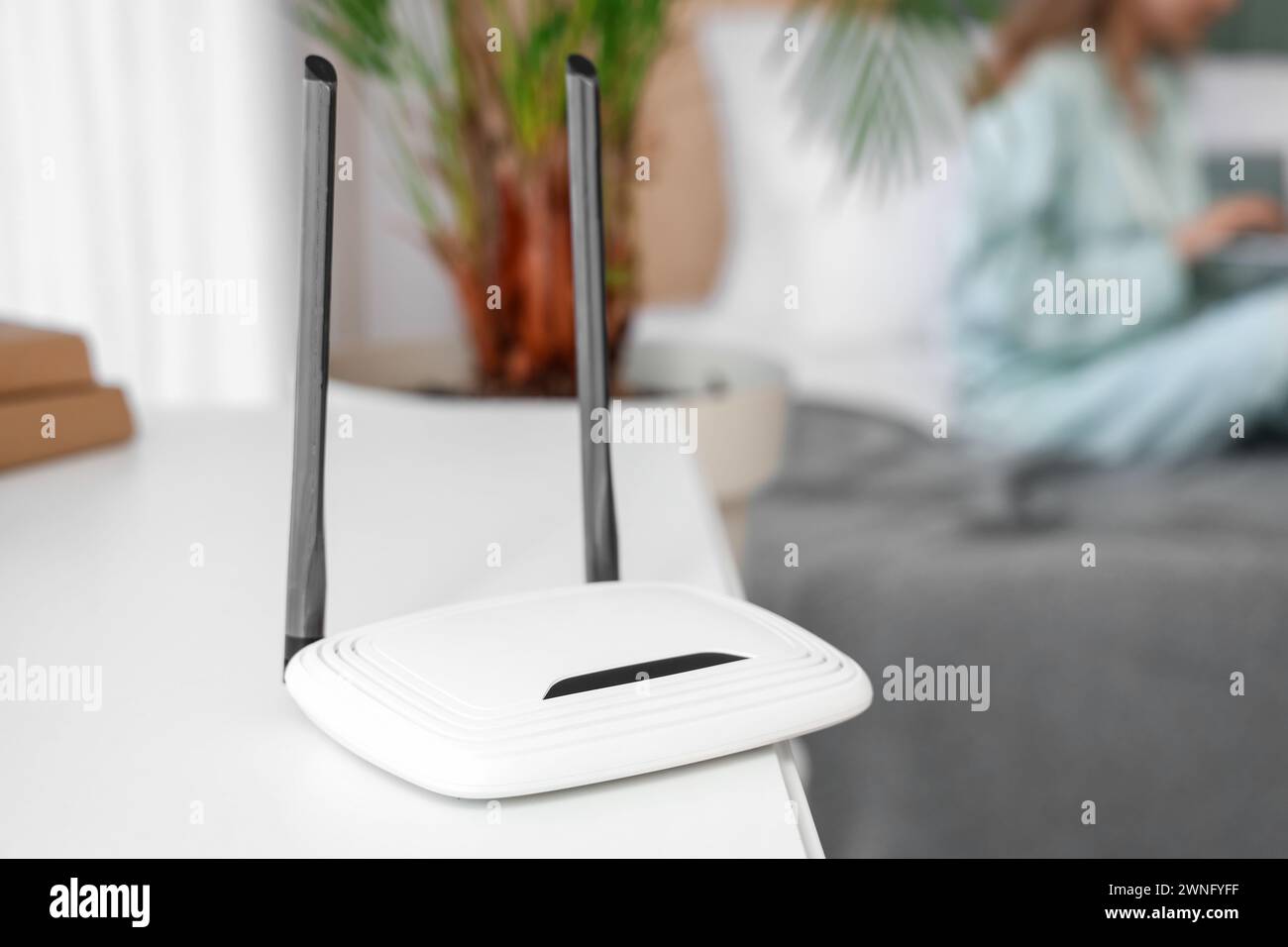 Modern wi-fi router on table in bedroom, closeup Stock Photo - Alamy