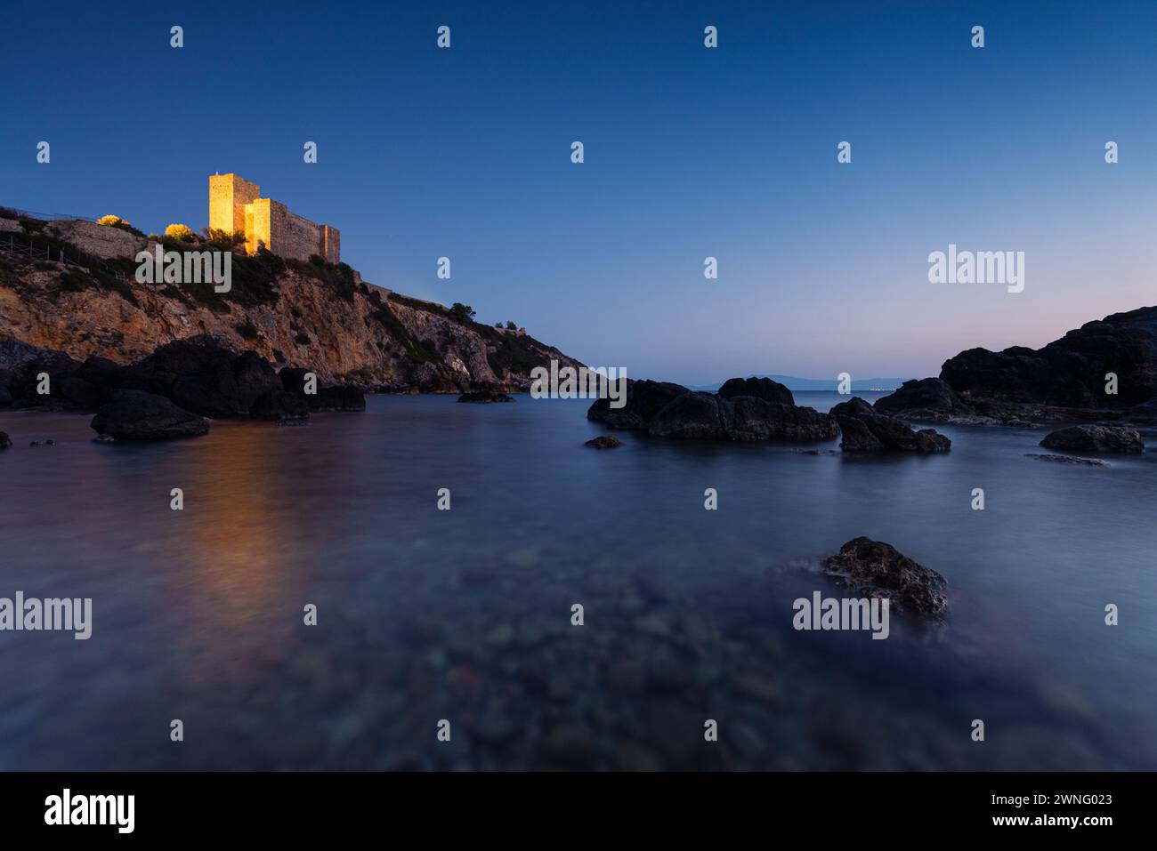 The Rocca Aldobrandesca castle on the rocky coast of Maremma in ...