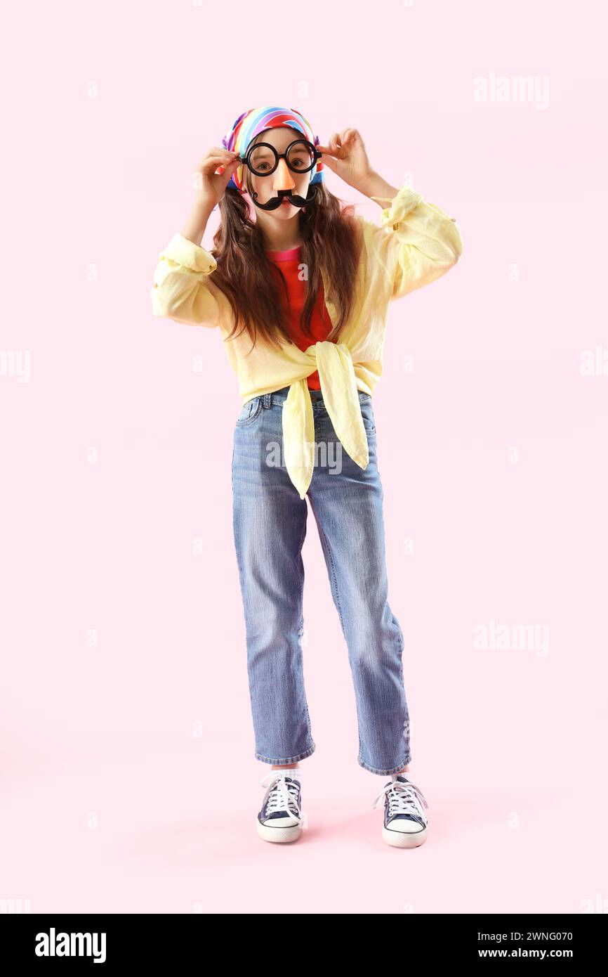Funny little girl in disguise on pink background. April Fools' Day ...