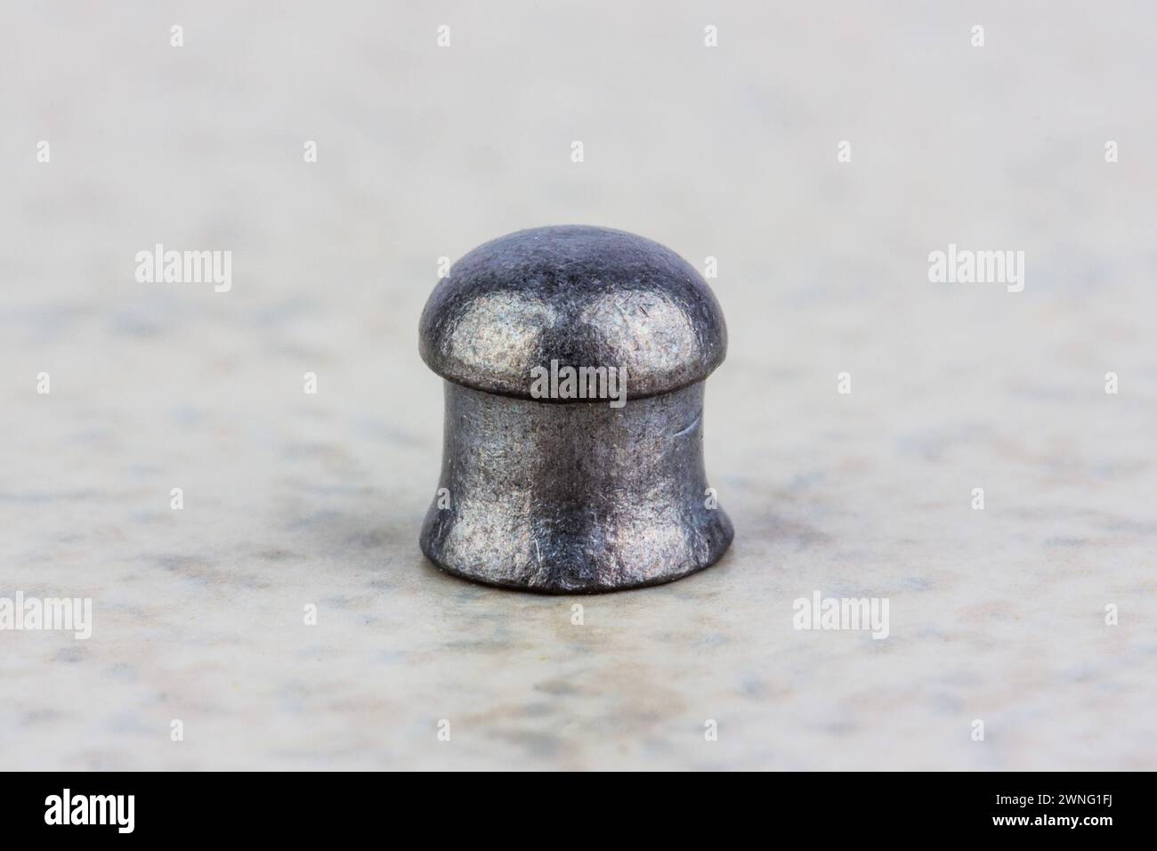 lead bullet for air guns on a gray background close up Stock Photo - Alamy