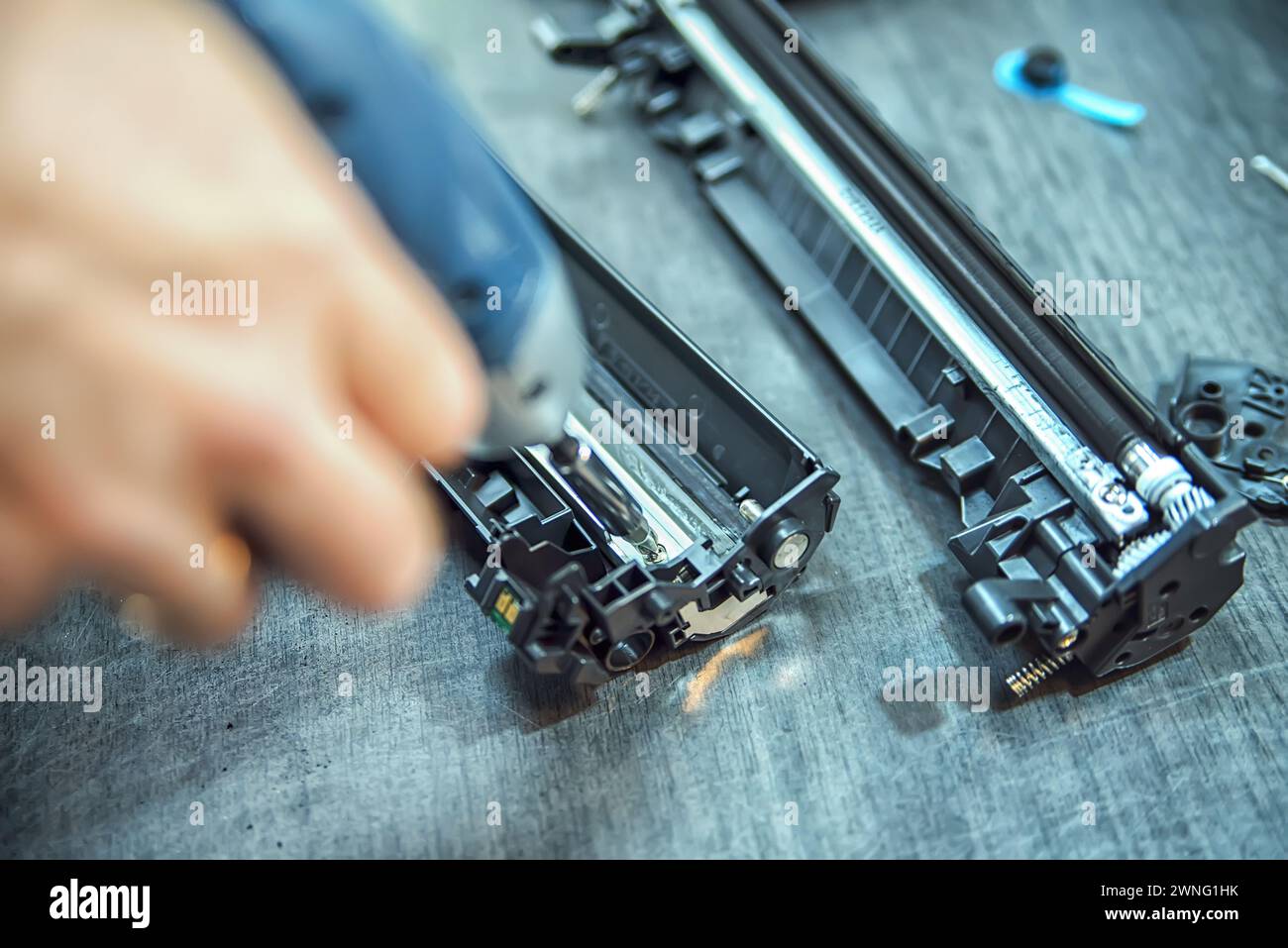 hands repairing laser toner cartridge, screw removal Stock Photo - Alamy