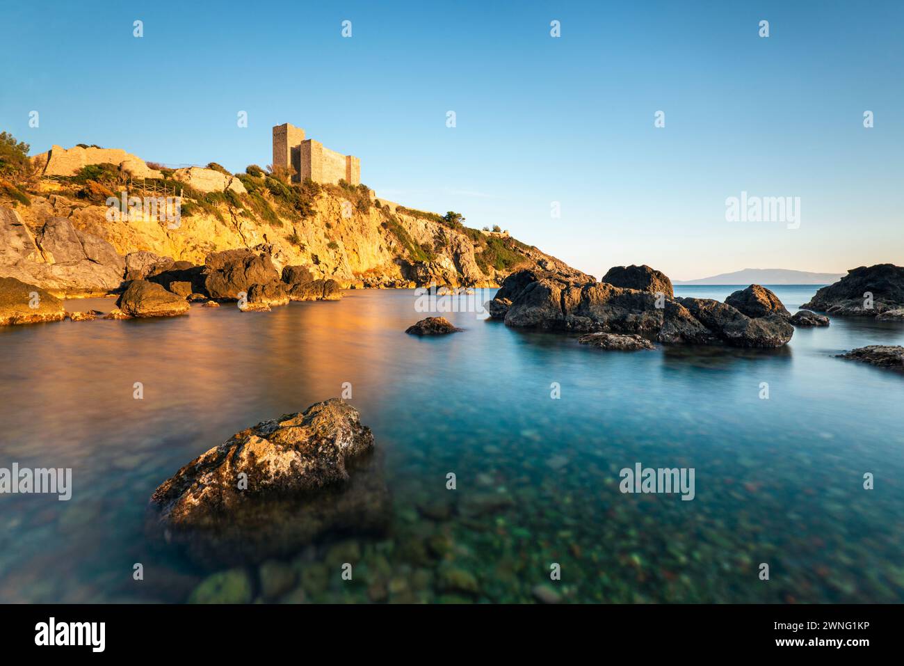 The Rocca Aldobrandesca castle on the rocky coast of the Maremma in ...