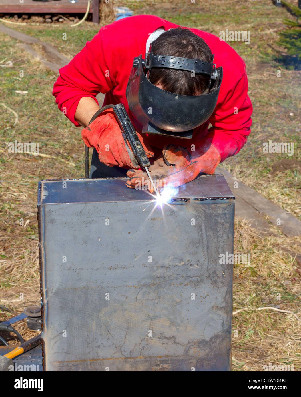a welder puts the seam on the metal electro arc welding Stock Photo - Alamy