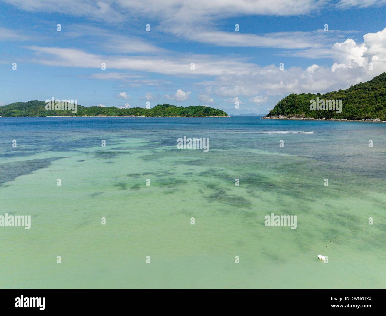 Beach with turquoise sea water and waves. Cagbuli Island. El Nido ...