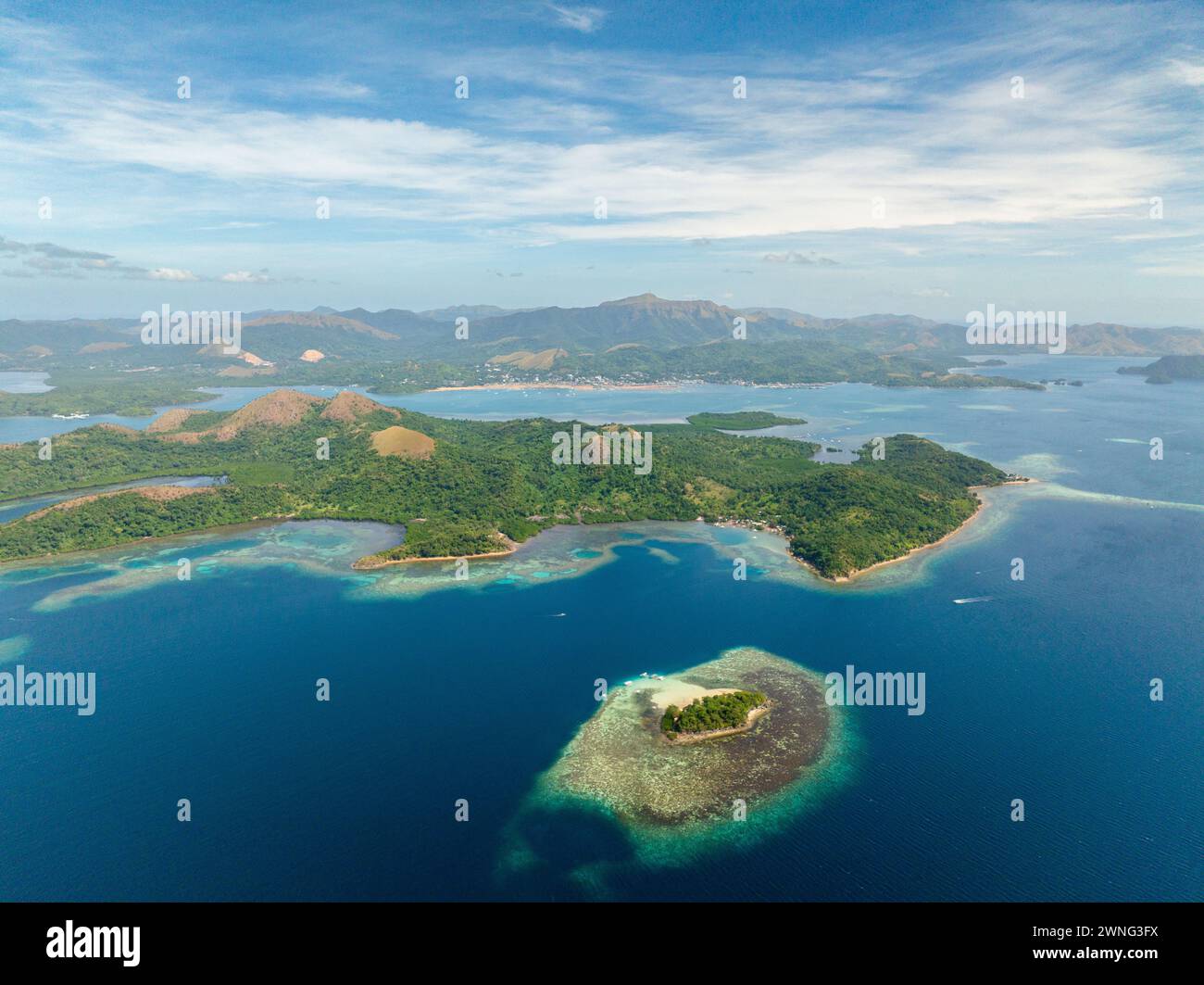 CYC Beach with white sand beach. Boats running over the blue sea. Coron ...