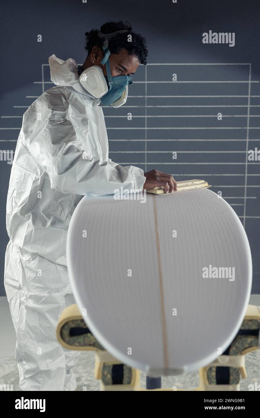 Surfboard manufacturing, Shaper working on board details. Concept of ...