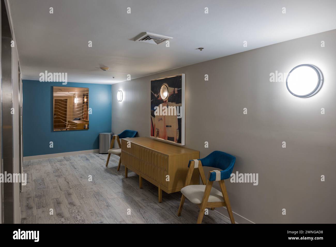 Beautiful view of hotel corridor near elevator furnished with chairs ...