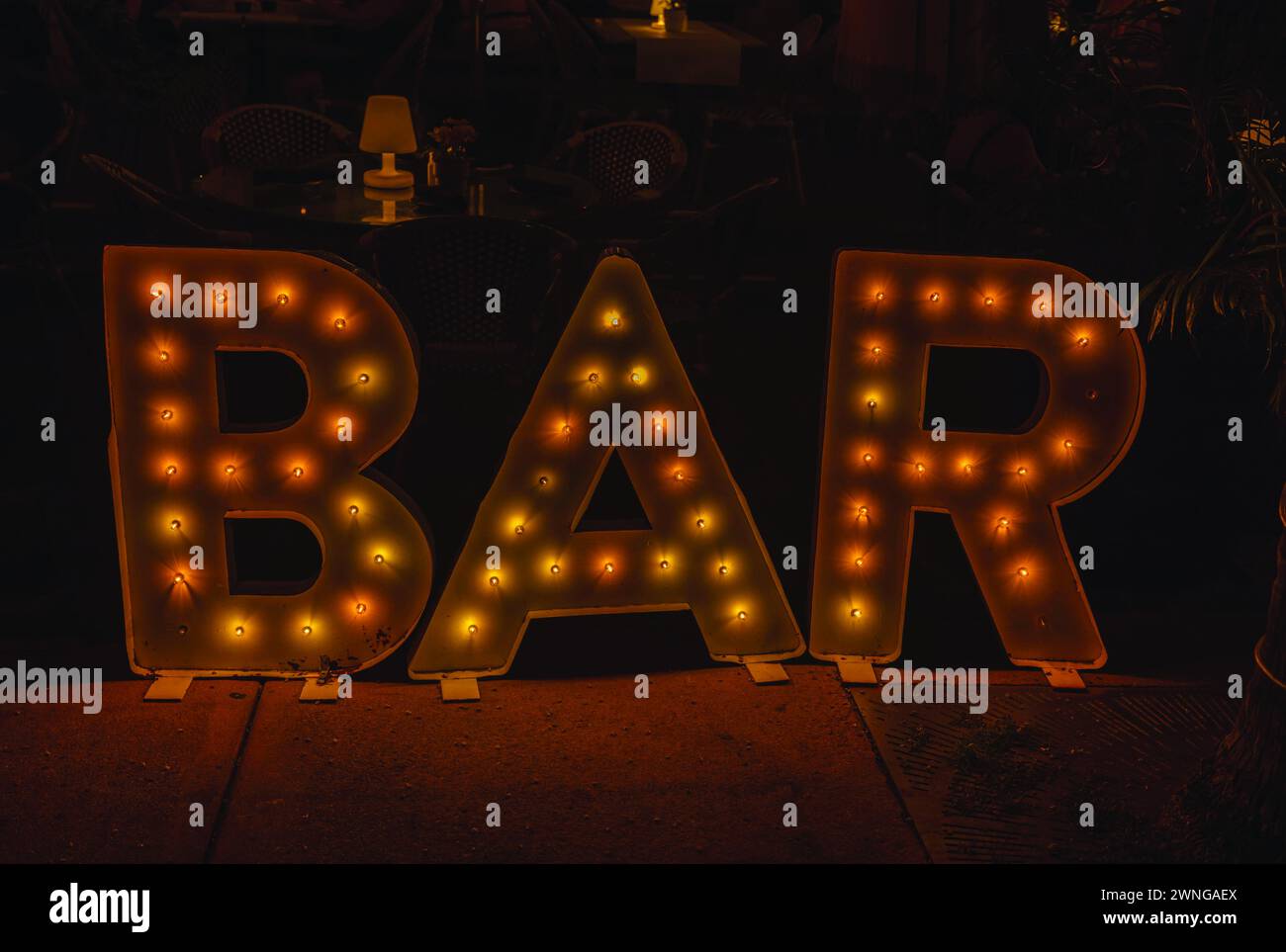 Close-up nighttime view featuring an LED lights banner that reads "BAR ...