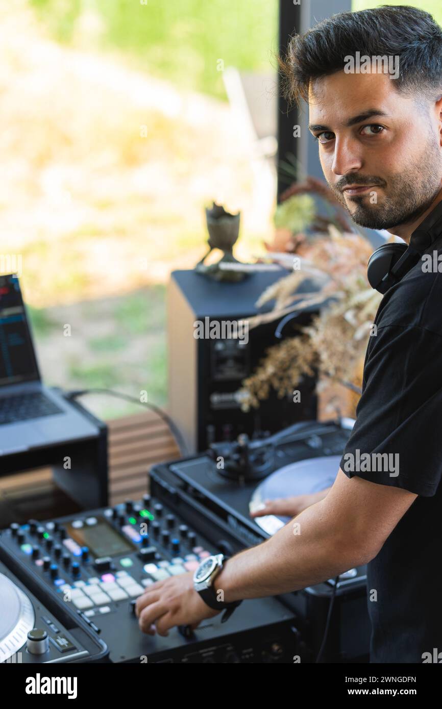 DJ doing playback at a party to take a break from the mixing desk Stock ...