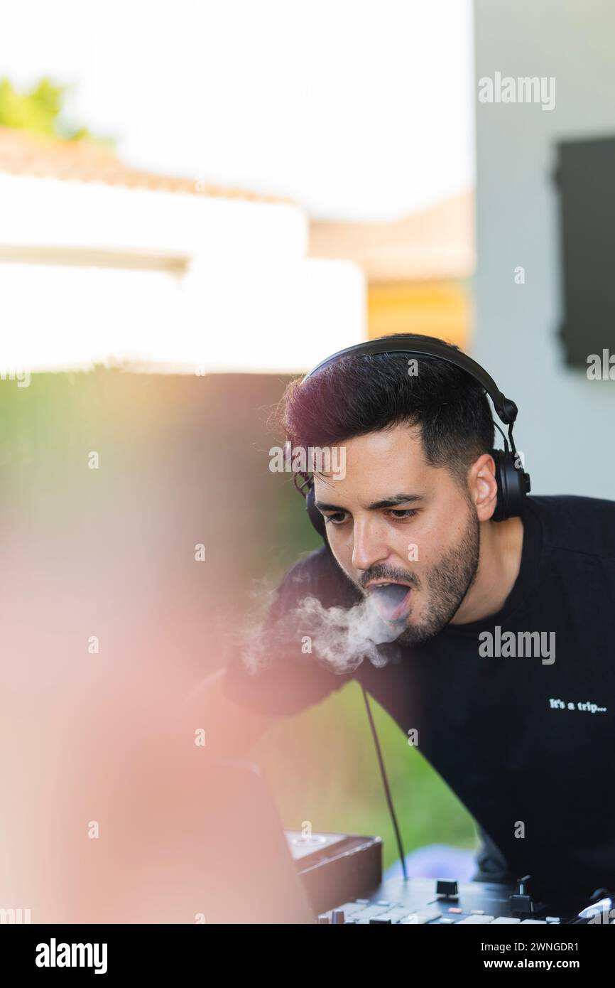 Portrait of a young dj smoking cannabis crazy during a party Stock ...