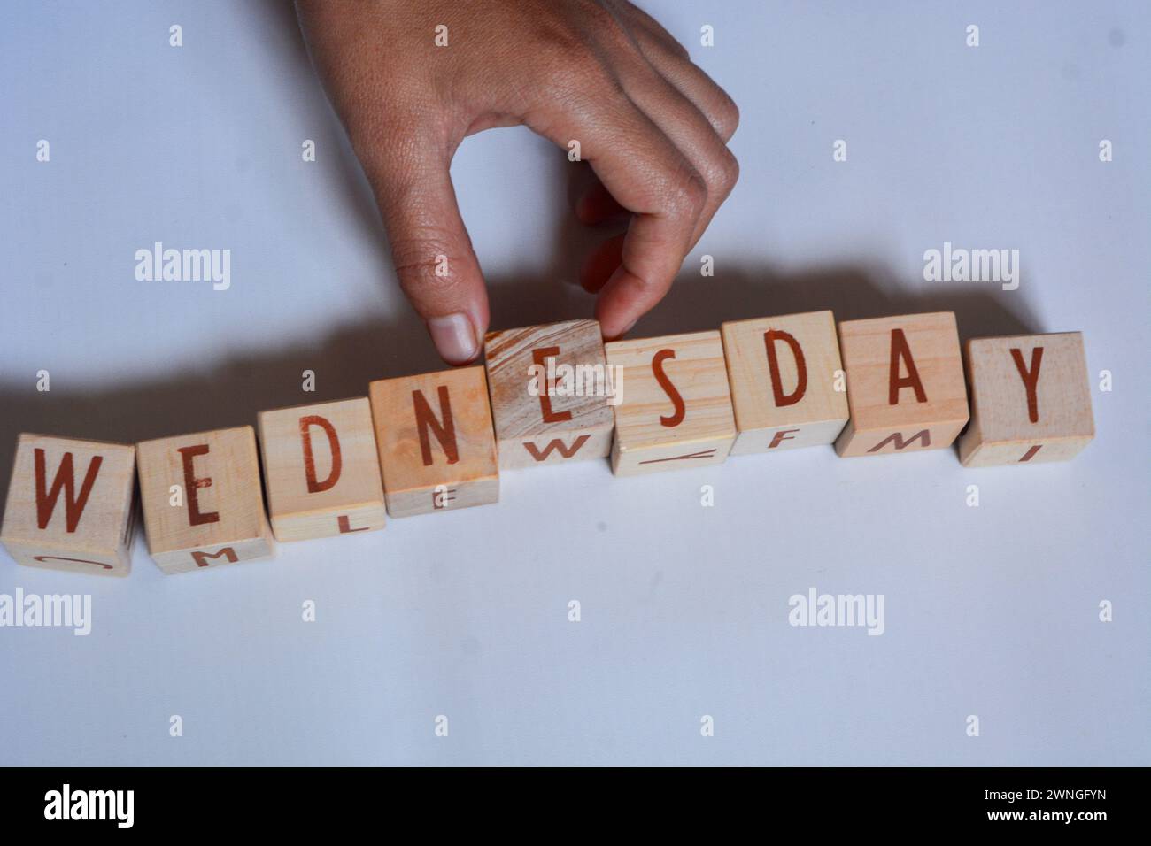 English vocabulary "WEDNESDAY" with medium brown wooden blocks, pink ...