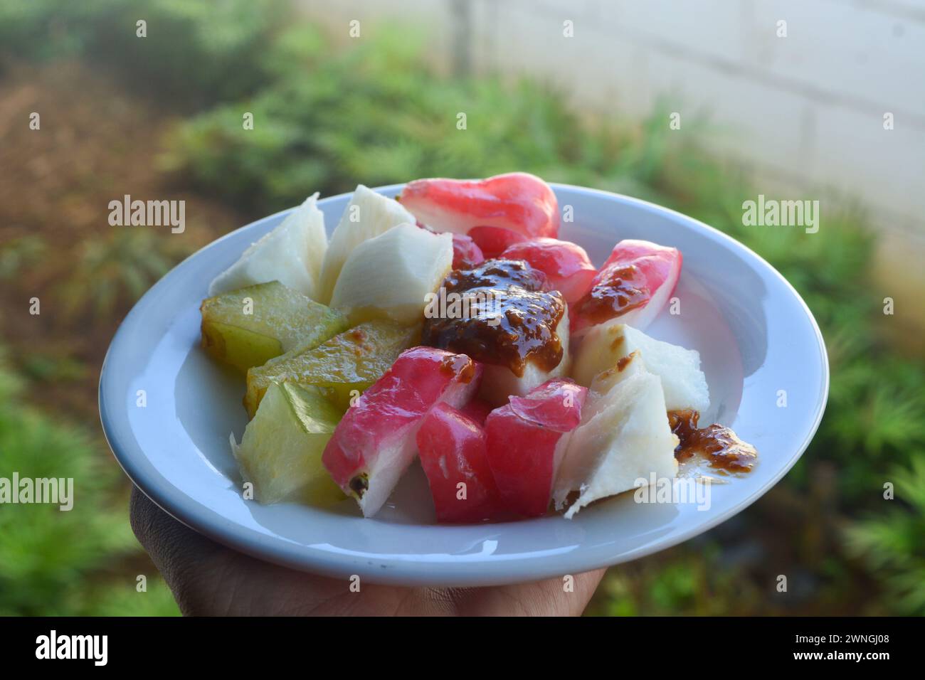 Photo of a variety of fruit "Rujak" with sauce made from brown sugar ...