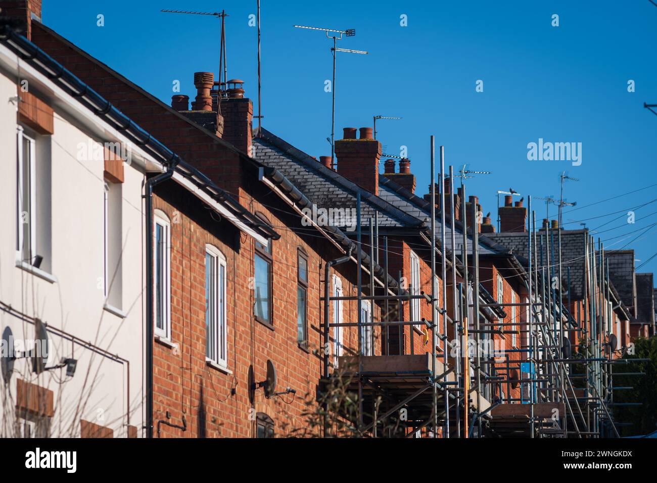 Row terrace red brick houses during external insulation works in ...