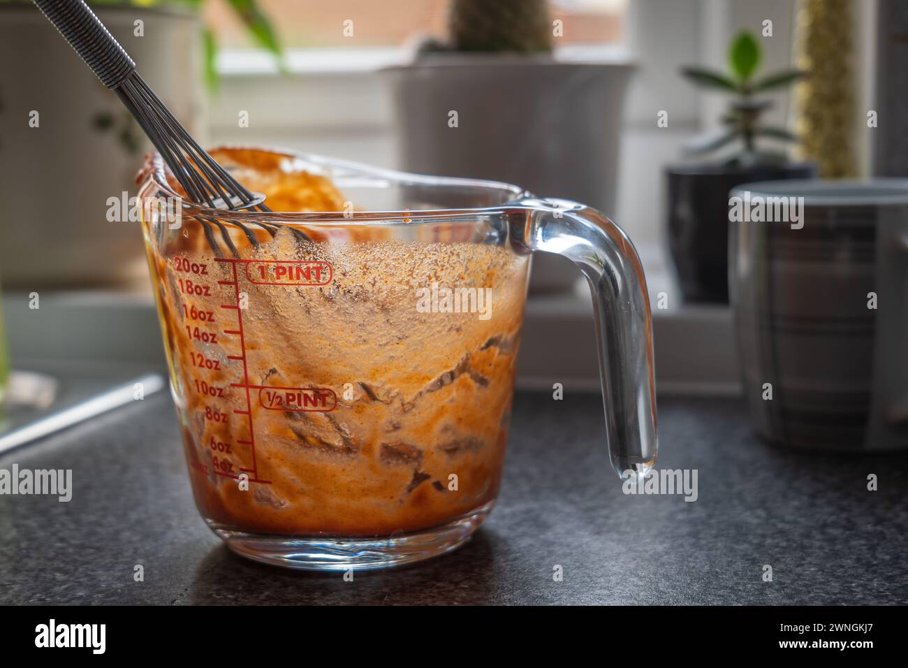 Used filthy measure jar with red sauce leftovers Stock Photo - Alamy
