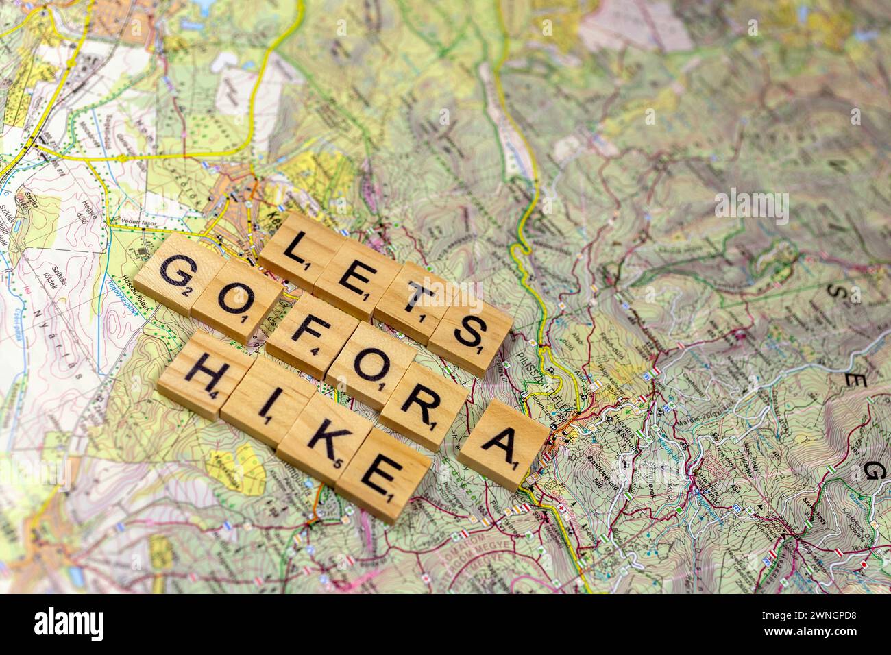 "Let's go for a hike" wooden letters on an old paper map Stock Photo ...