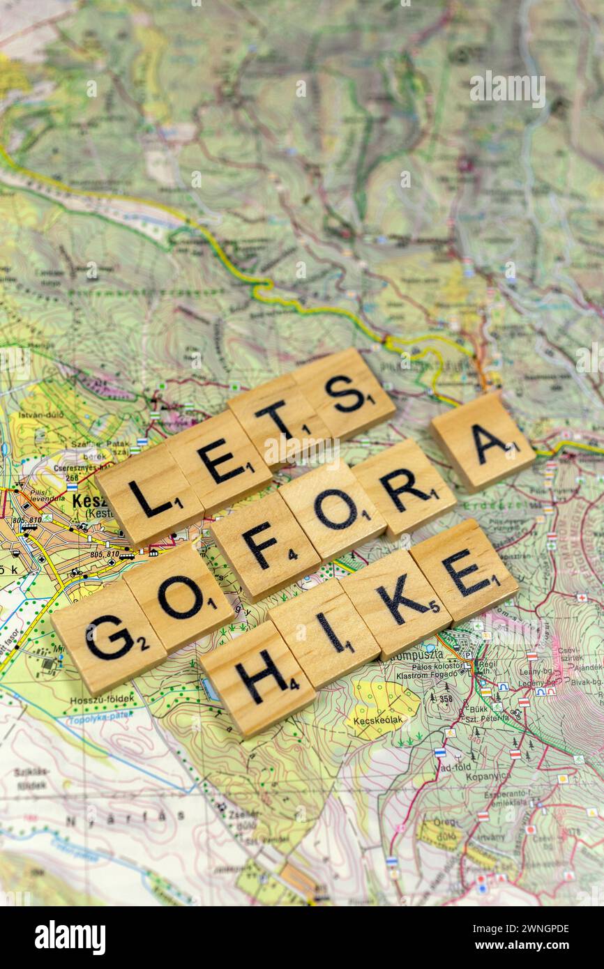 "Let's go for a hike" wooden letters on an old paper map Stock Photo ...
