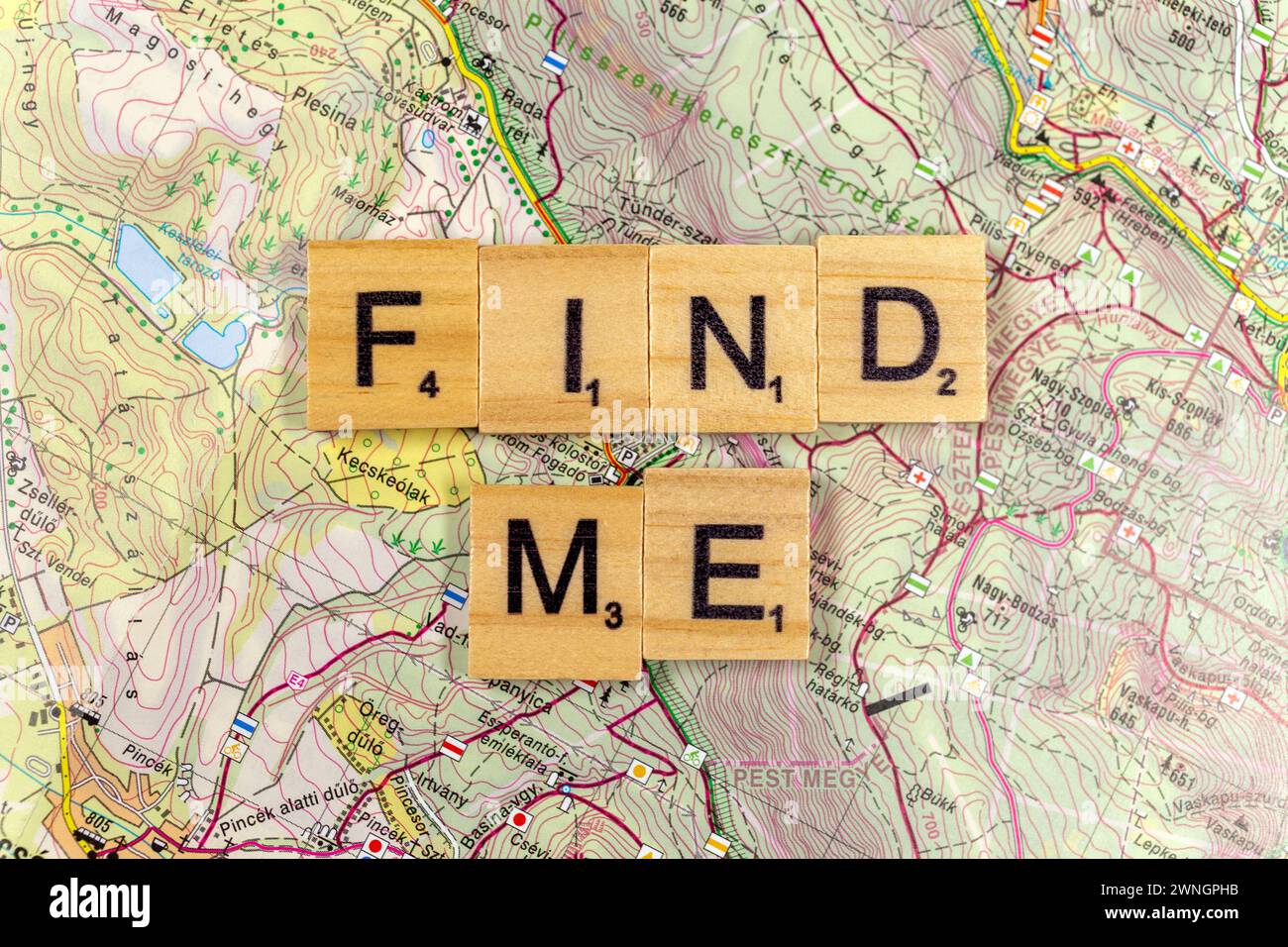"Find me" wooden letters on an old paper map Stock Photo - Alamy