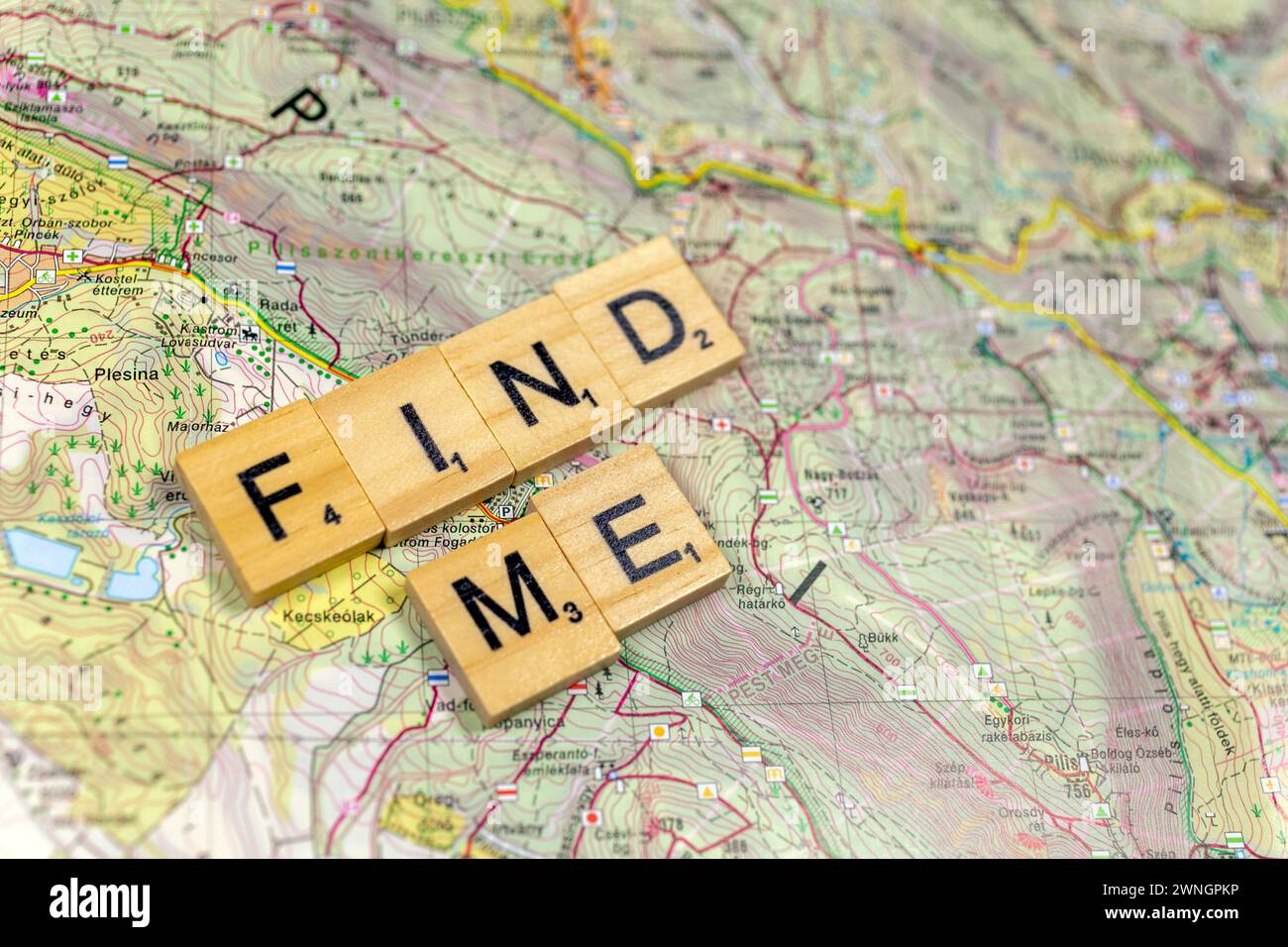 "Find me" wooden letters on an old paper map Stock Photo - Alamy