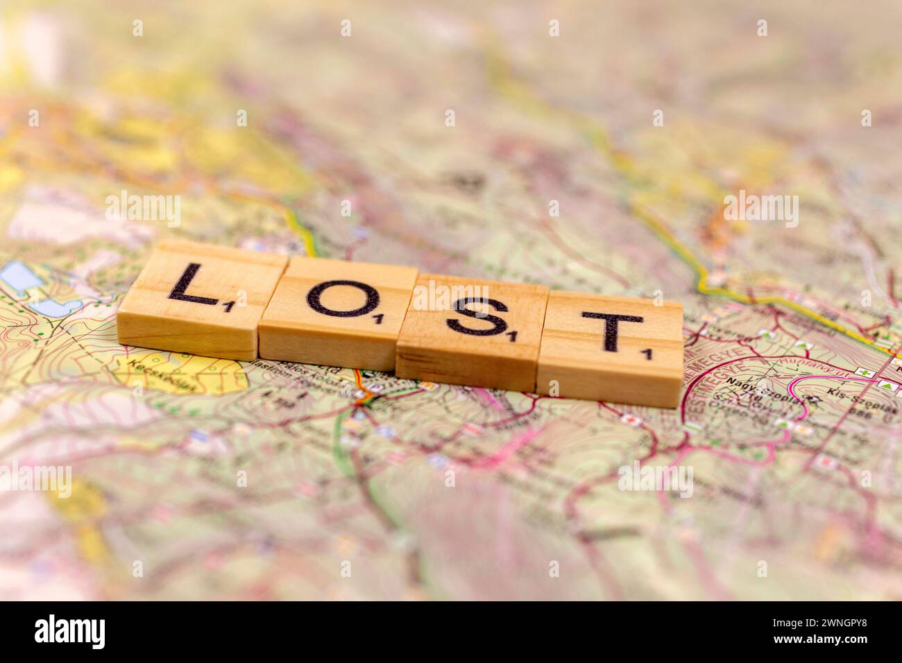 Lost wooden letters on an old paper map Stock Photo - Alamy