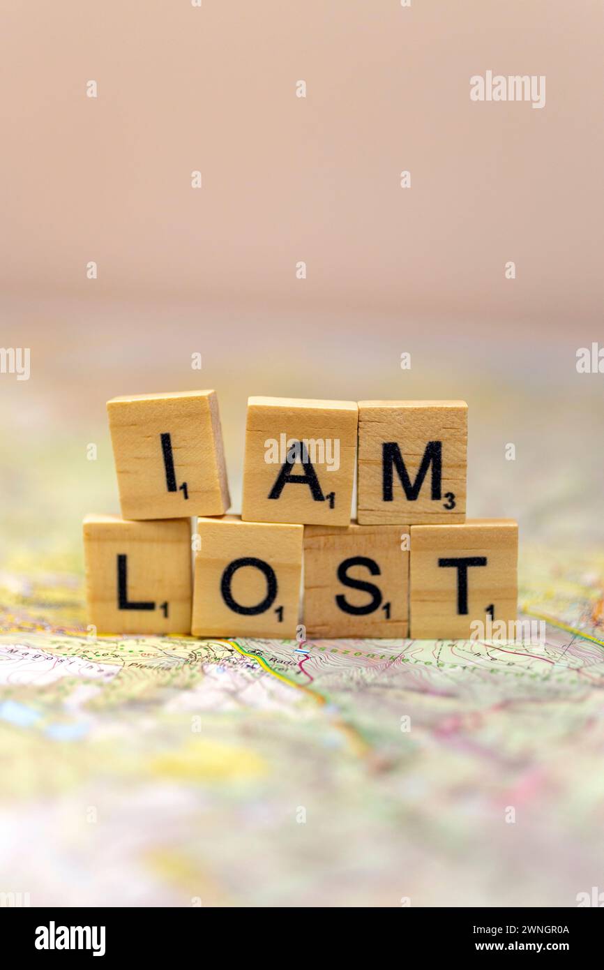 I am lost wooden letters on an old paper map Stock Photo - Alamy