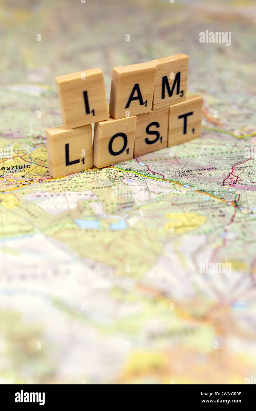 I am lost wooden letters on an old paper map Stock Photo - Alamy