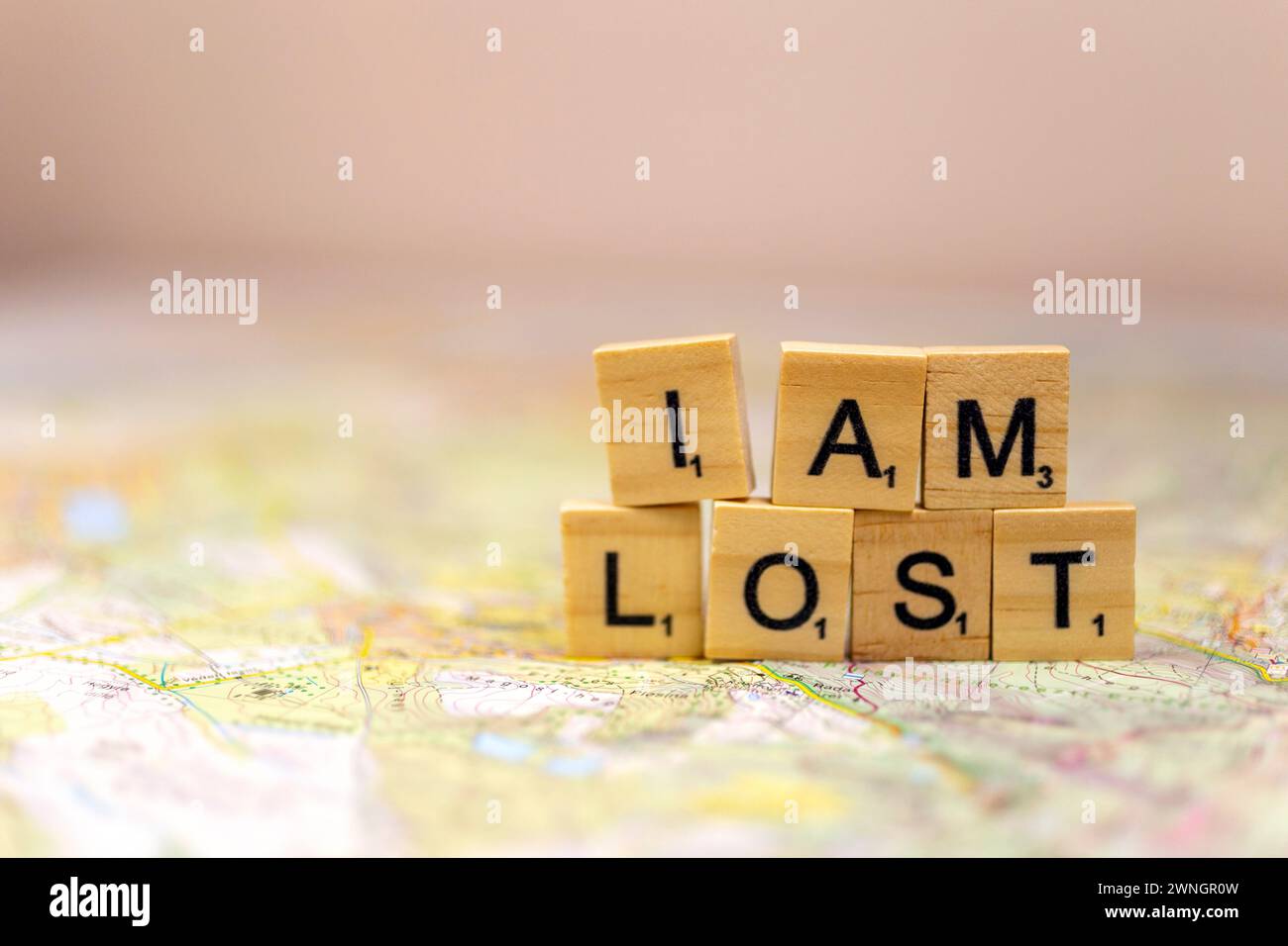 I am lost wooden letters on an old paper map Stock Photo - Alamy