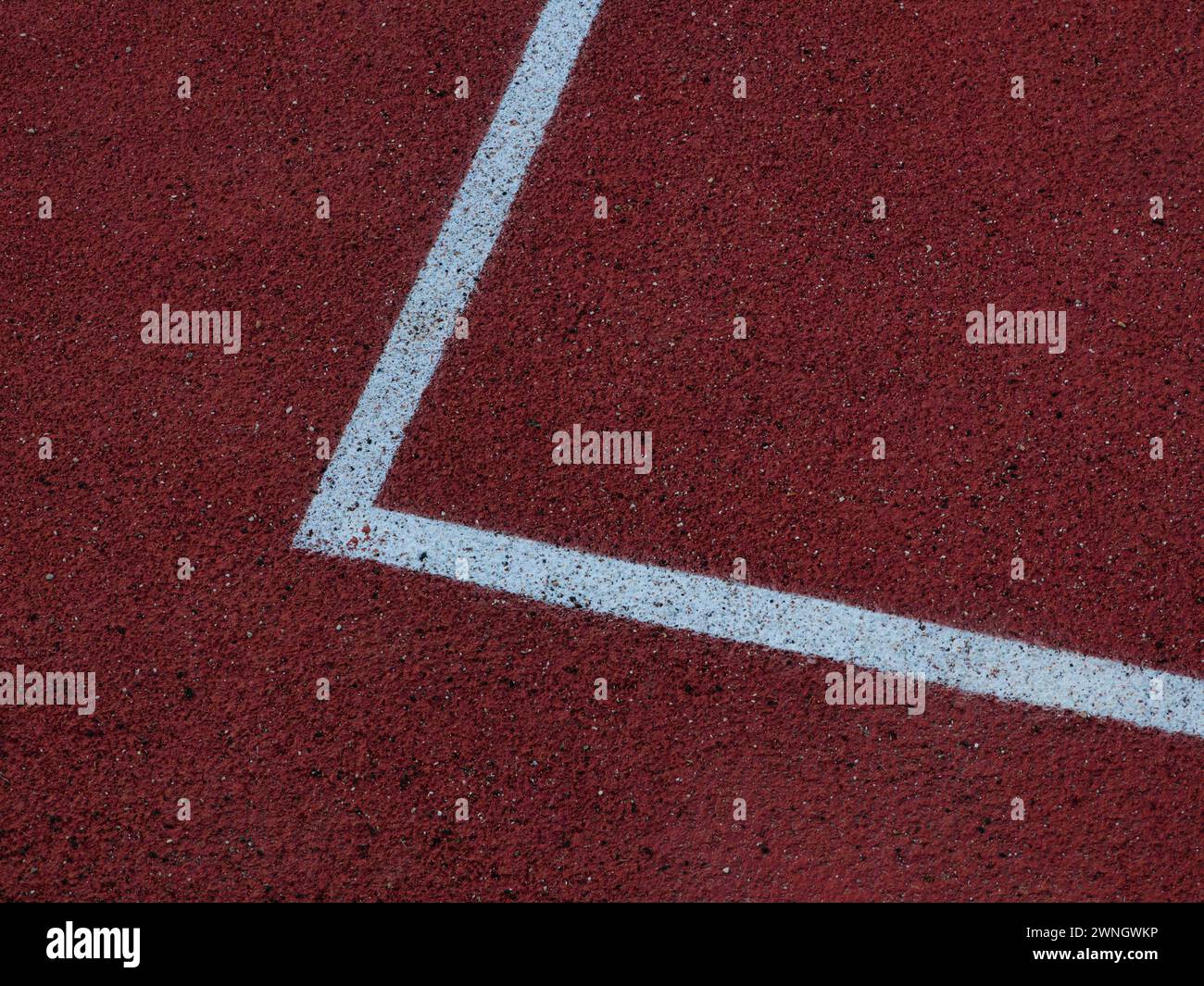 Courtside contrast. Red floor and white lines outdoor basketball court ...