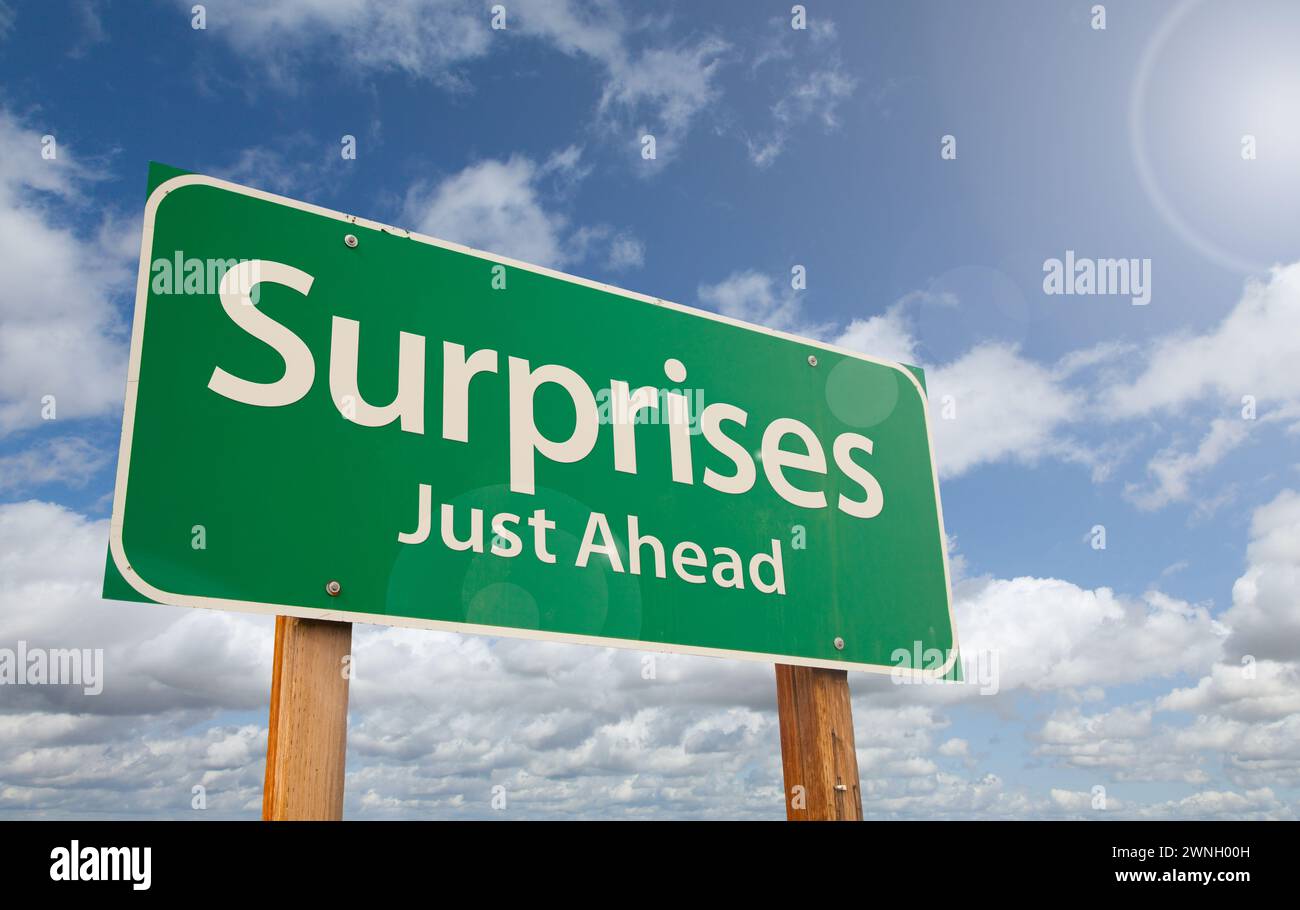 Surprises Just Ahead Green Road Sign Over Clouds and Blue Sky Stock ...