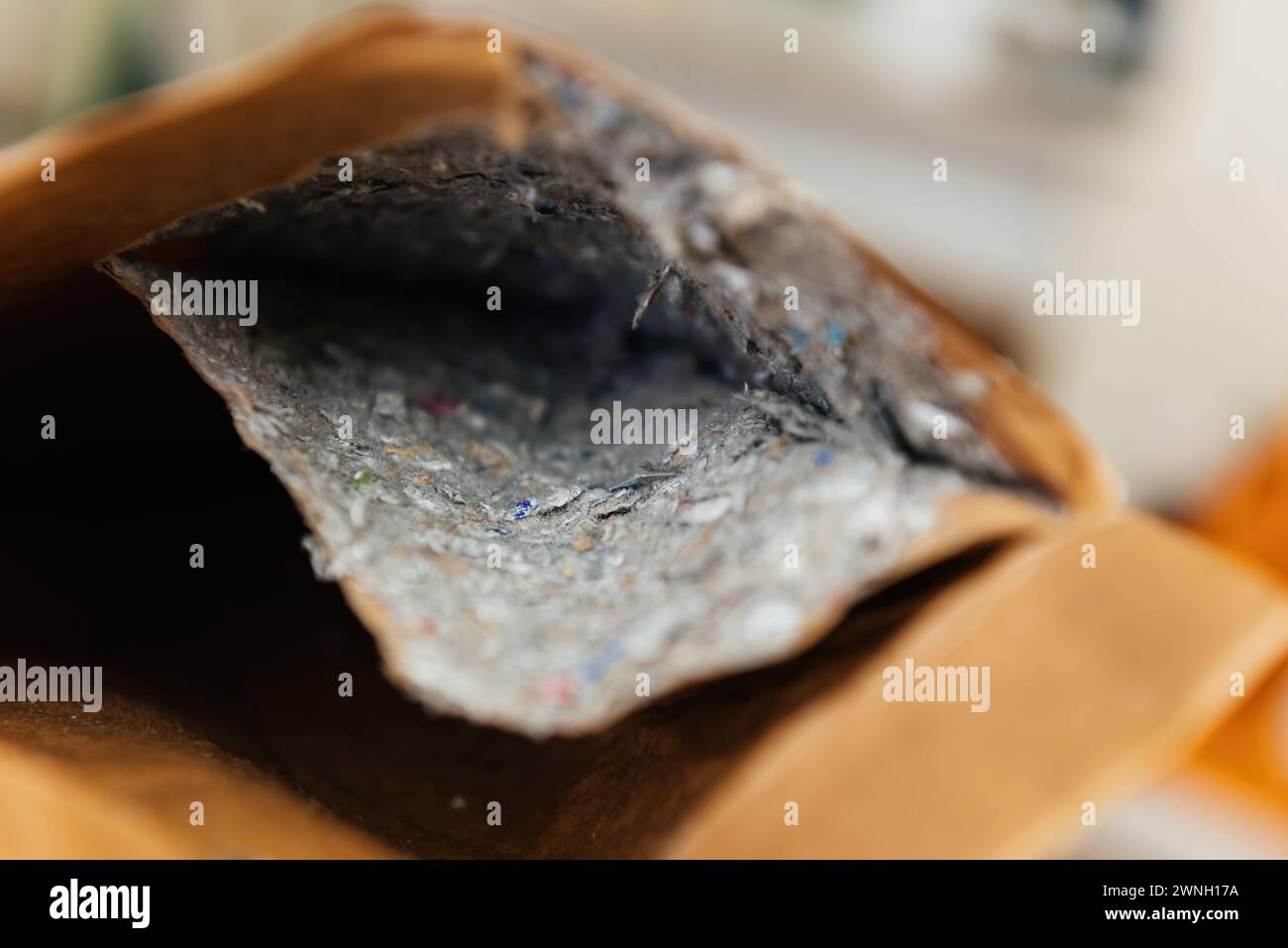 Macro close-up reveals recycled material inside an envelope ...