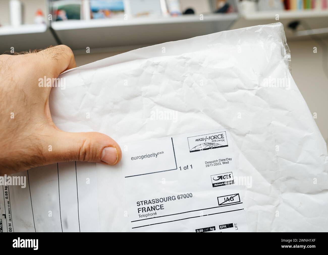 Paris, France - Dec 28, 2023: An arm holds an envelope featuring the ...