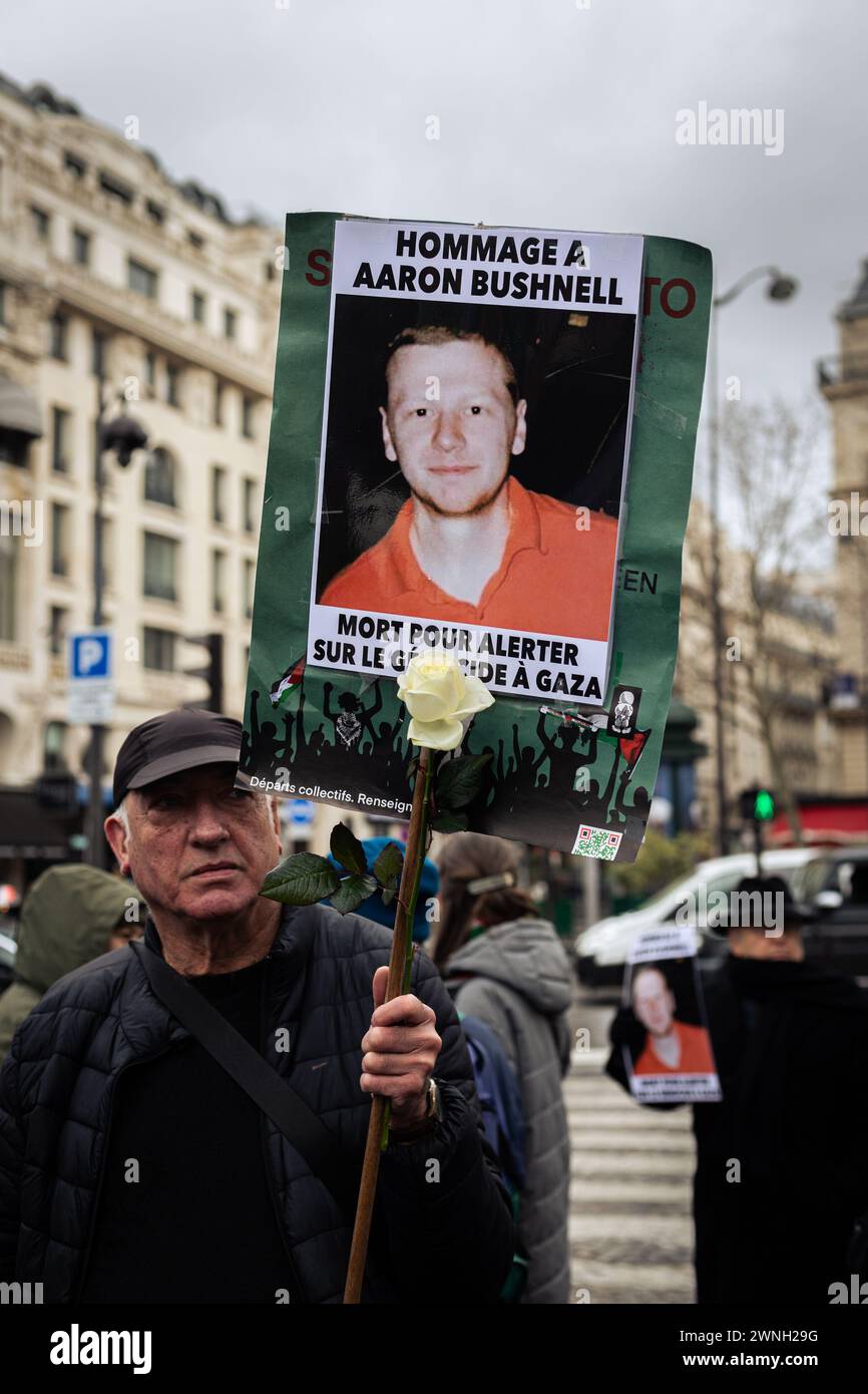 A man holds a placard with photo of Aaron Bushnell, during the ...