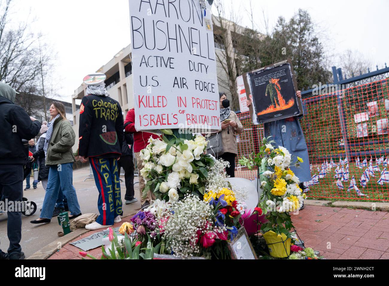 Flowers are left on a memorial for Aaron Bushnell as demonstrators ...