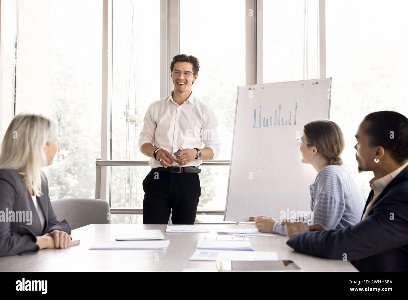 Young male boss make flip chart presentation for company clients Stock ...