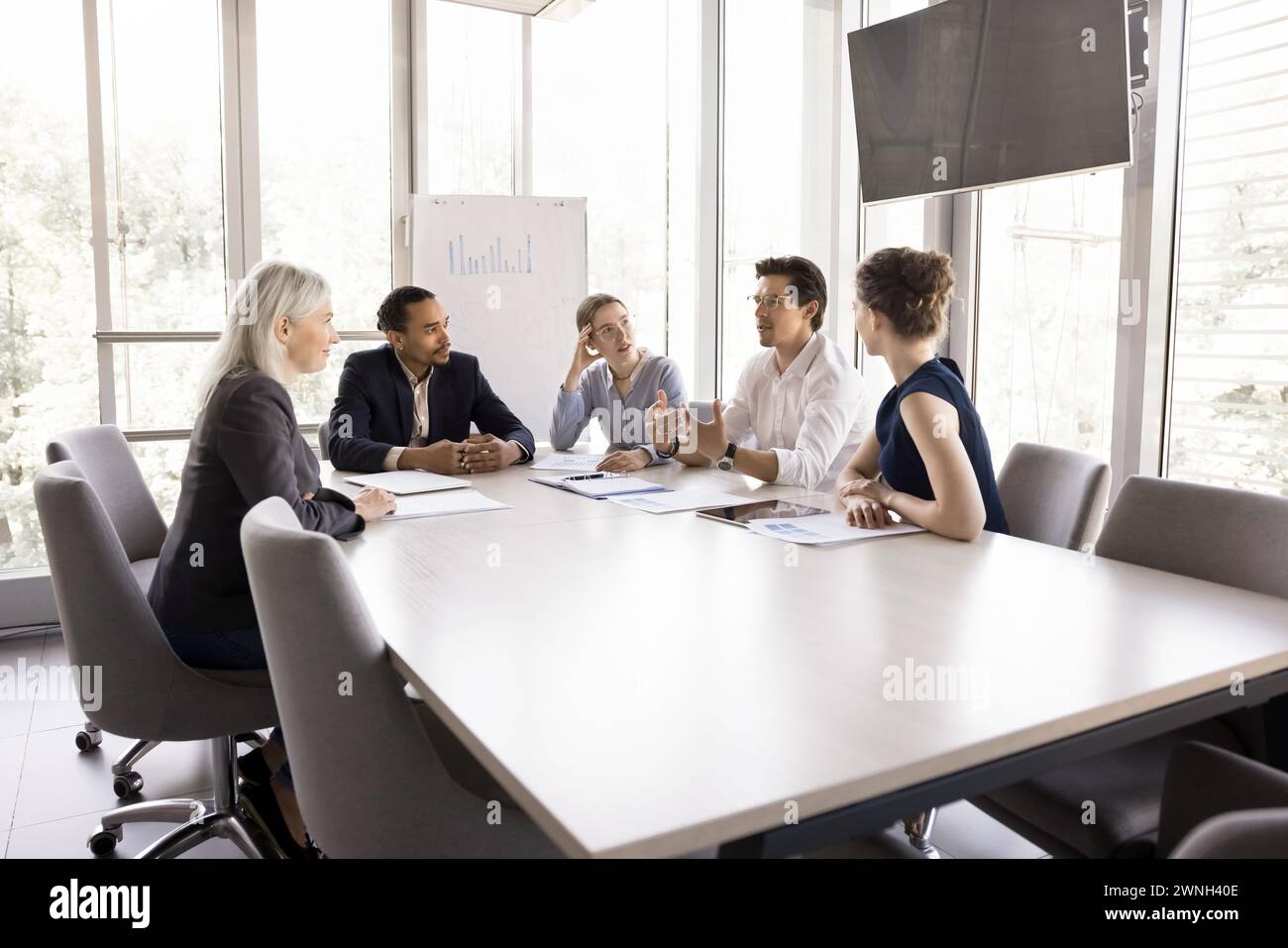 Five diverse office employee listen to male boss make speech Stock ...