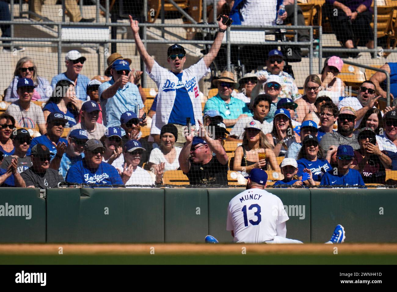 Los Angeles Dodgers third baseman Max Muncy (13) reacts after missing a ...