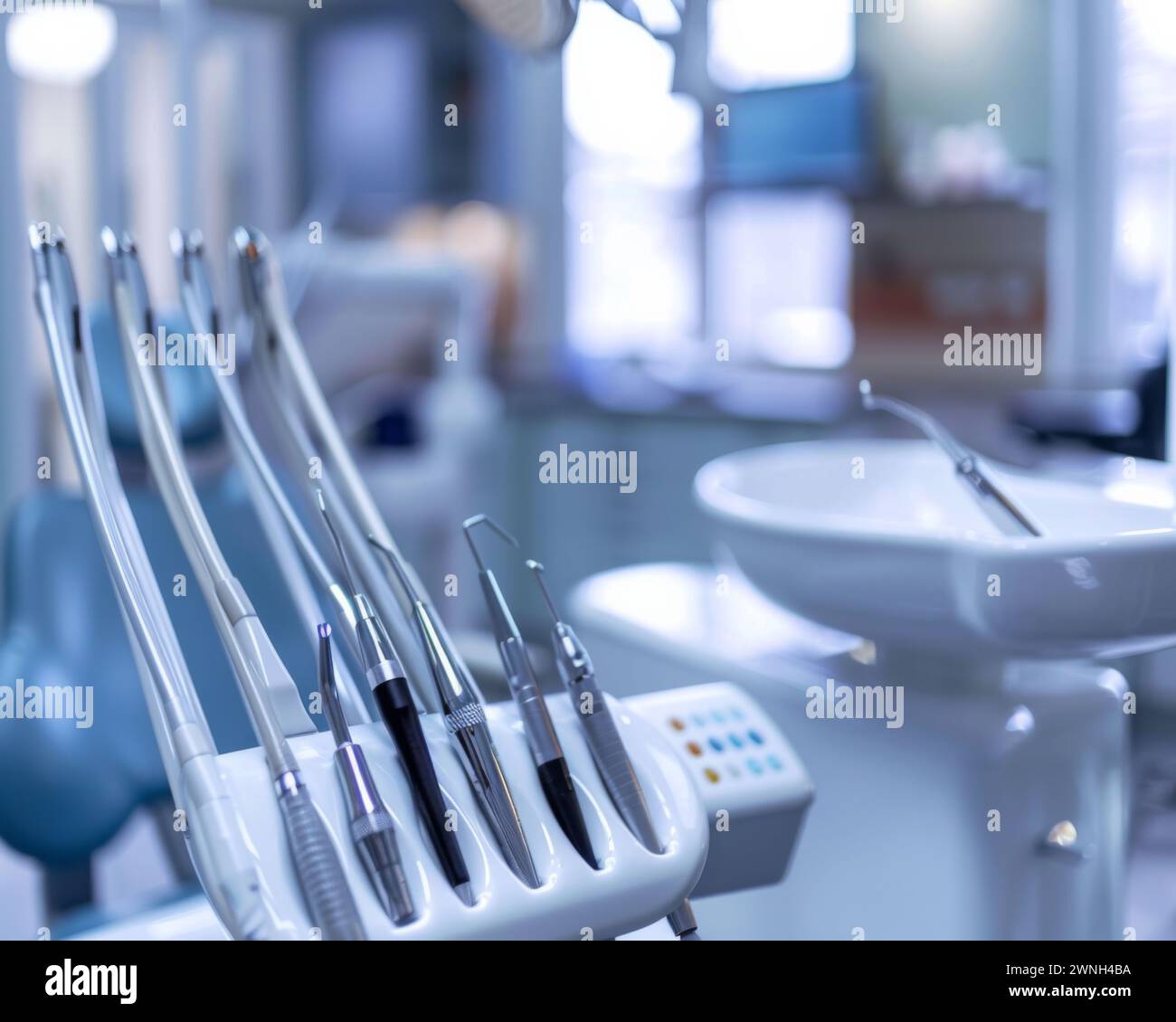 A collection of dental instruments neatly arranged in a row next to a ...