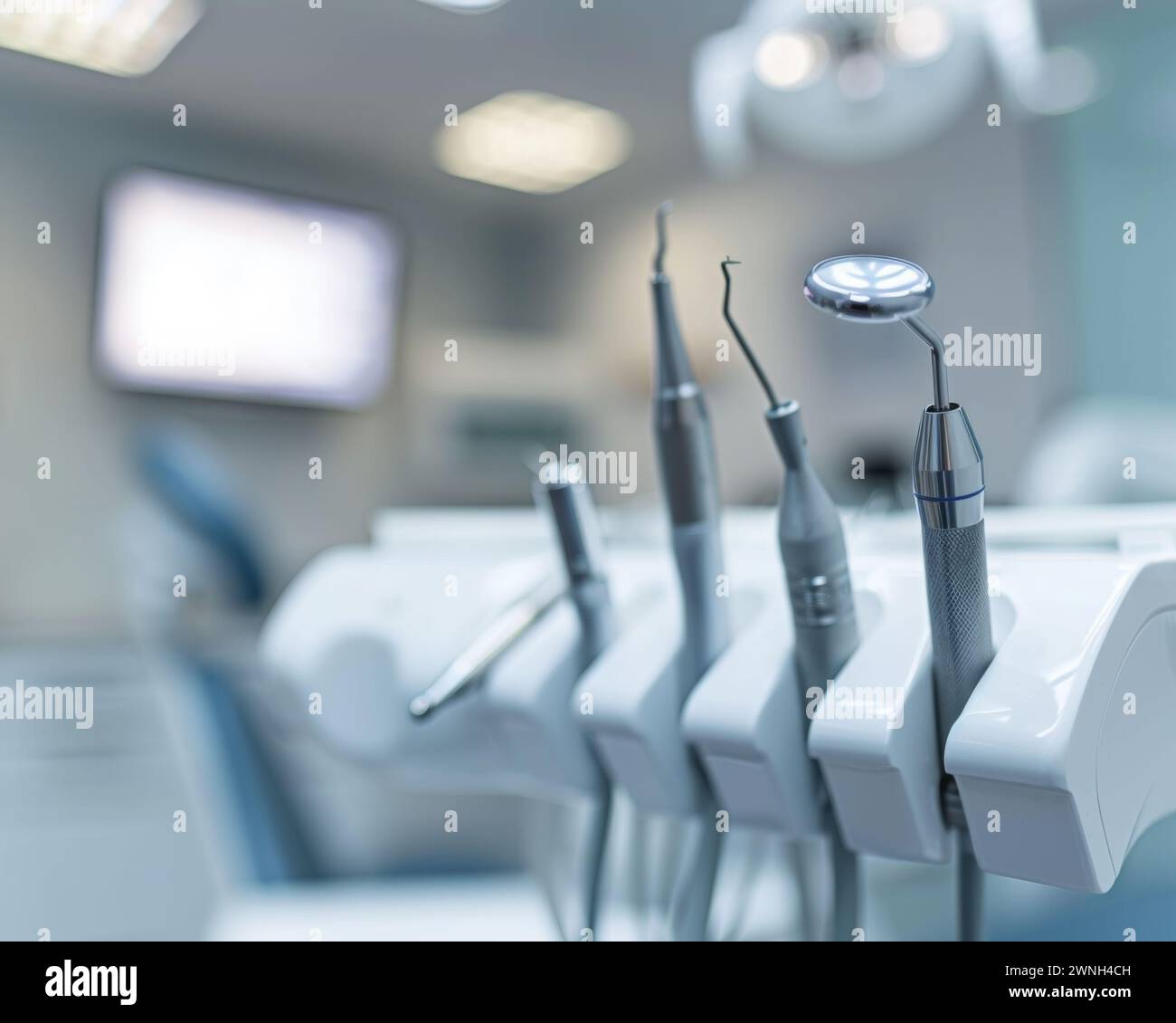 A collection of dental instruments neatly arranged on a table in a row ...