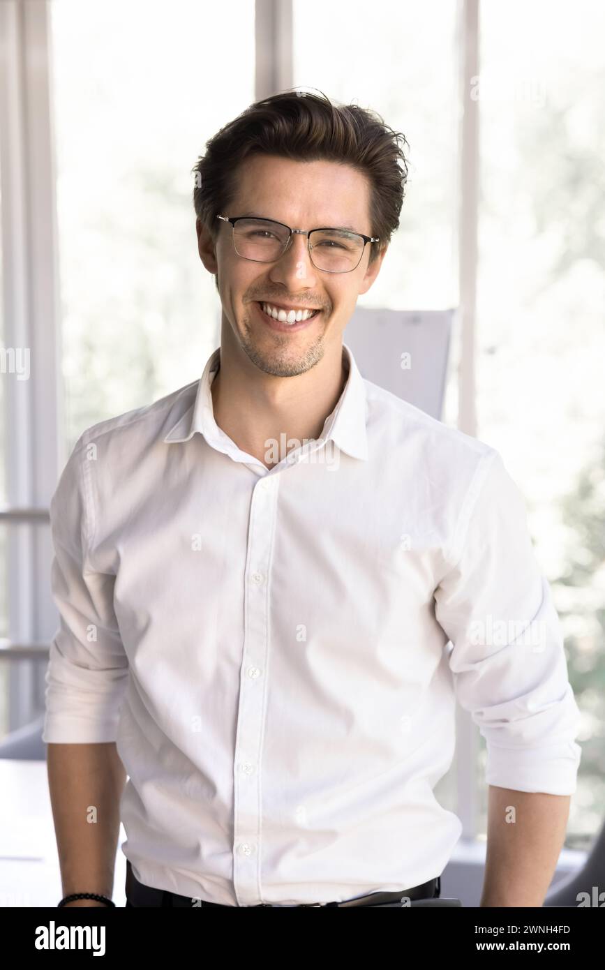 Vertical portrait successful man office employee pose at workplace ...