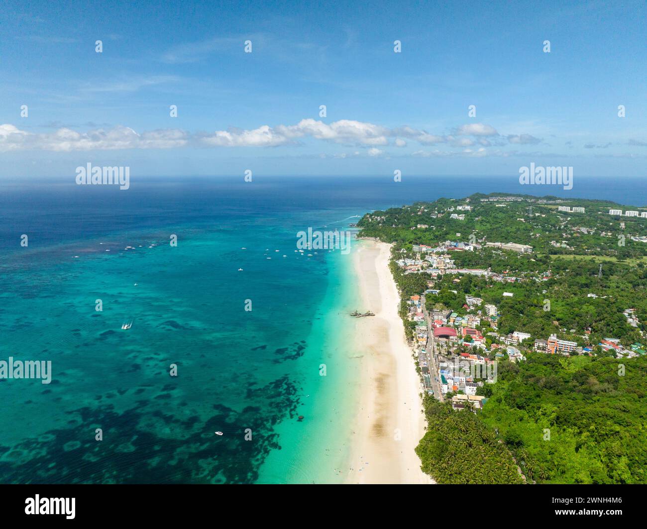 Tourist boats running over the clear turquoise water. White sand beach ...
