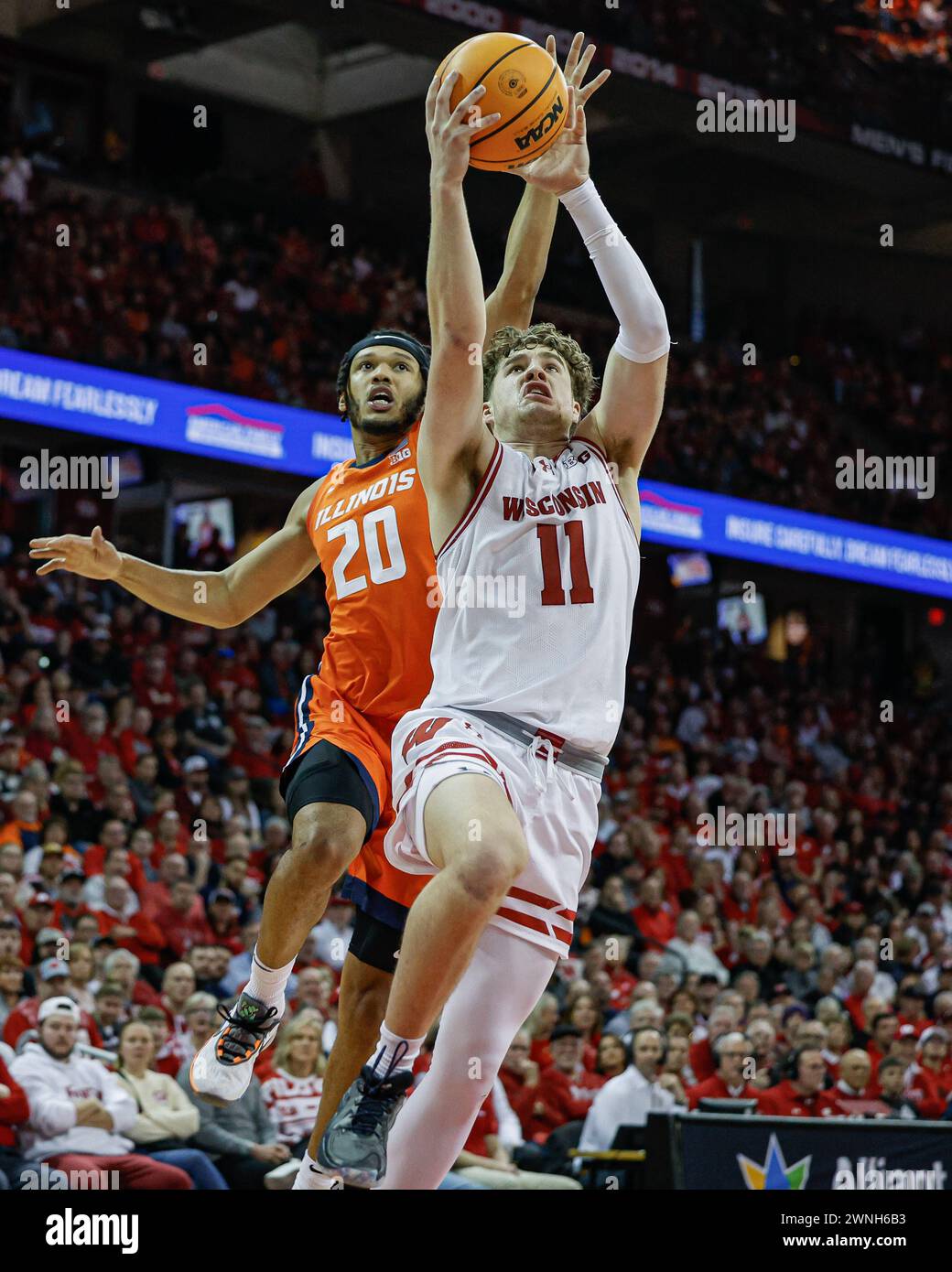 Madison, WI, USA. 2nd Mar, 2024. Wisconsin Badgers guard Max Klesmit (11) makes a layup beyond ...