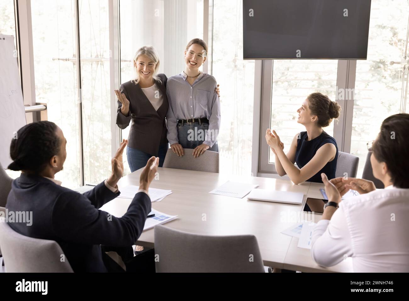 Middle-aged woman boss represent hug and supporting new employee Stock ...