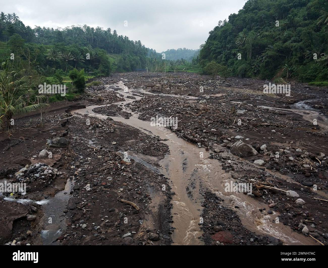 A view of the valley after the volcanic eruption. A mud river has ...