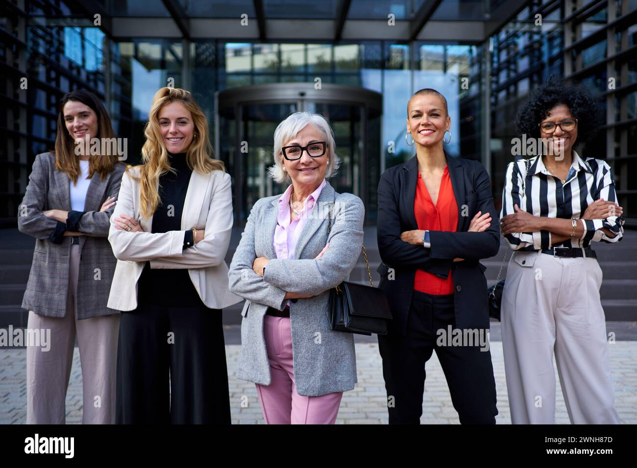Group successful diverse business formal women standing with arms ...